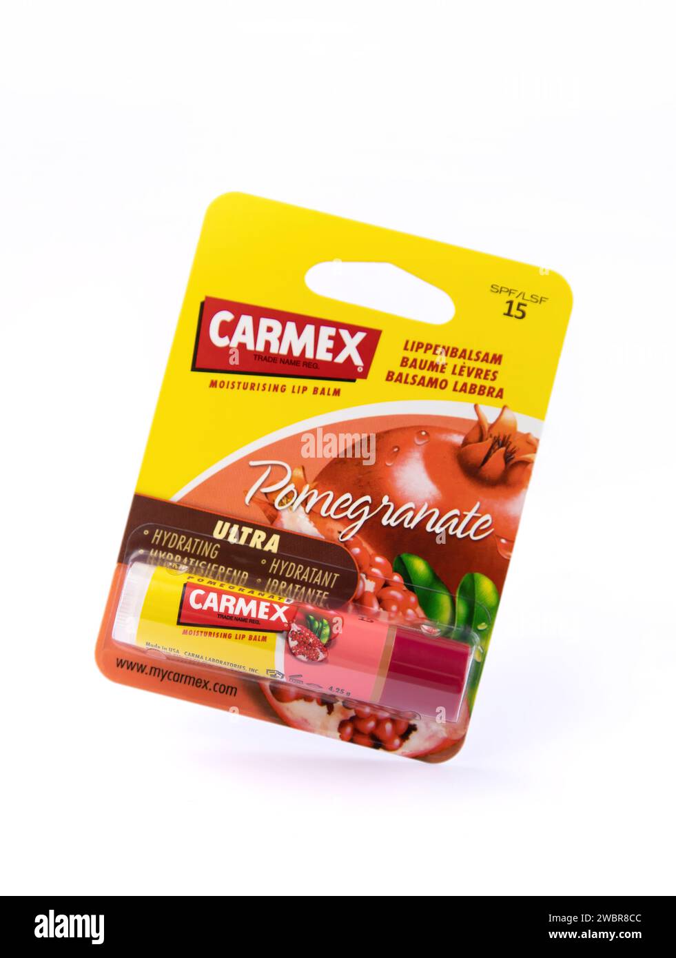 Carmex brand healing lip balm with pomegranate flavor. Standing on a ...