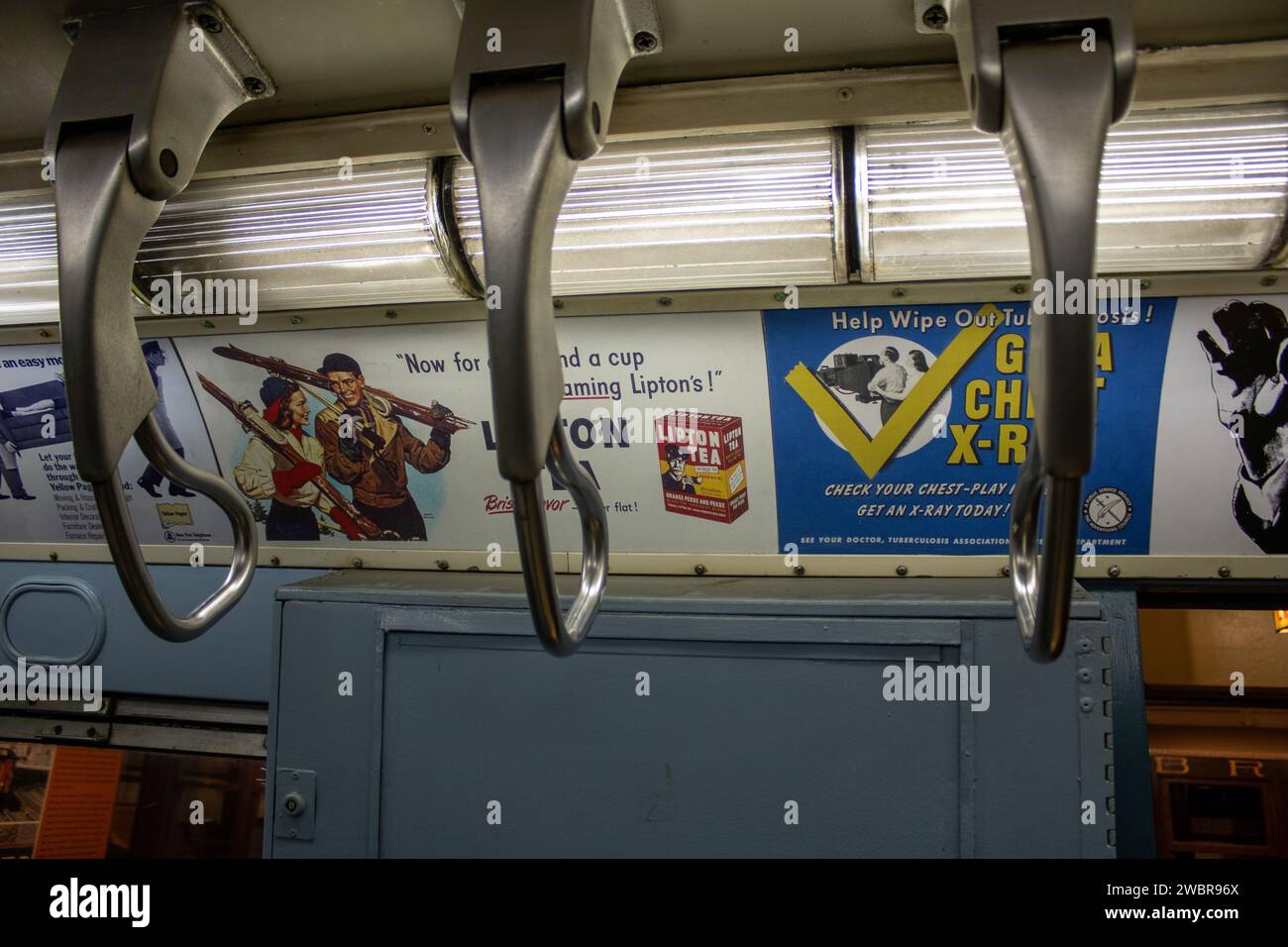 The interior of a subway train with multiple banners Stock Photo - Alamy