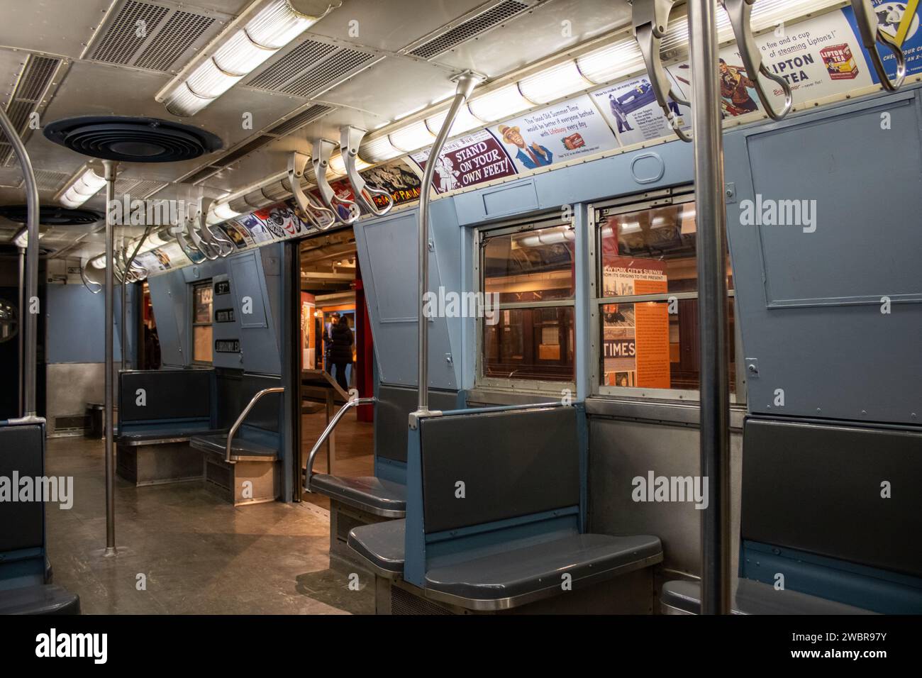 The interior of a subway train with multiple banners Stock Photo - Alamy
