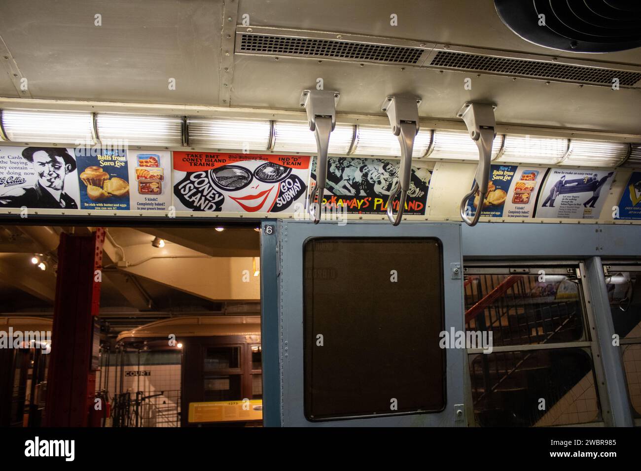 The interior of a subway train with multiple banners Stock Photo - Alamy