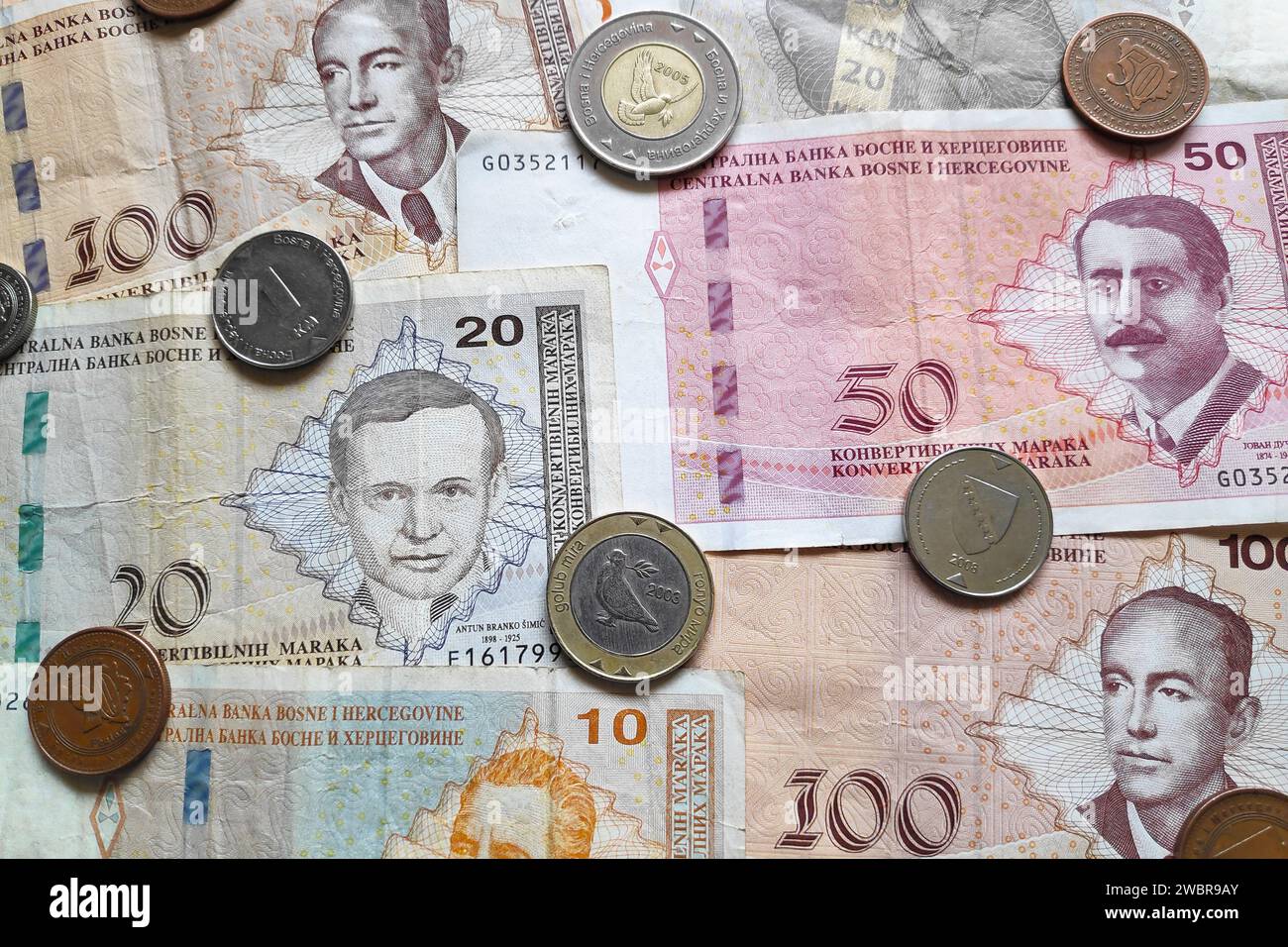 Stack of Bosnia and Herzegovina convertible mark banknotes and coins as ...