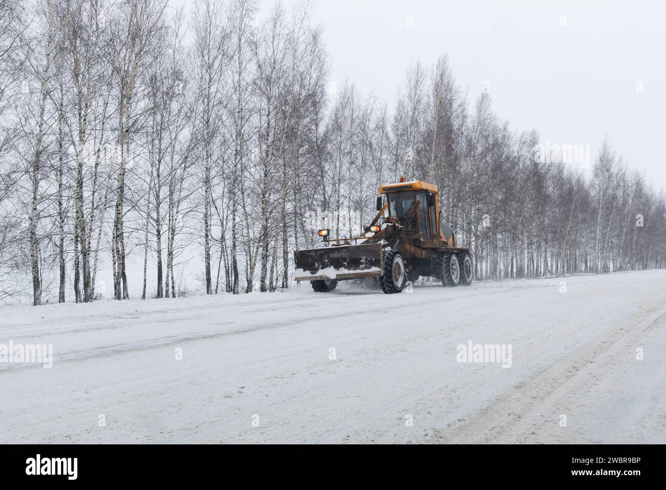 Snow removal equipment clears the road Stock Photo - Alamy