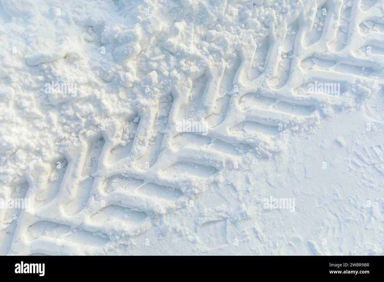 Tractor tracks on the snow, top view Stock Photo - Alamy