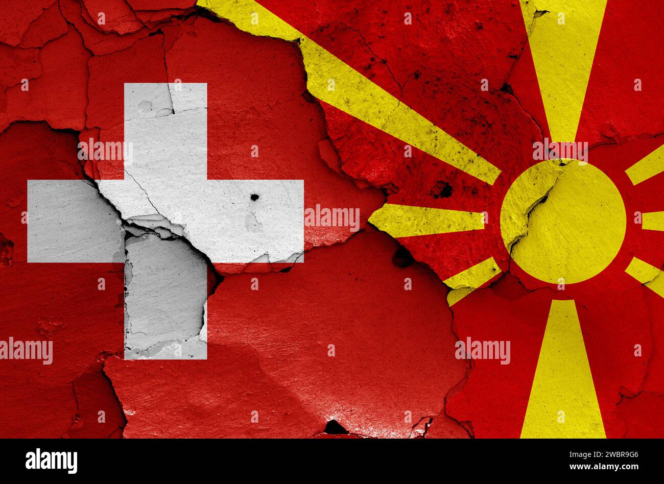 flags of Switzerland and North Macedonia painted on cracked wall Stock ...