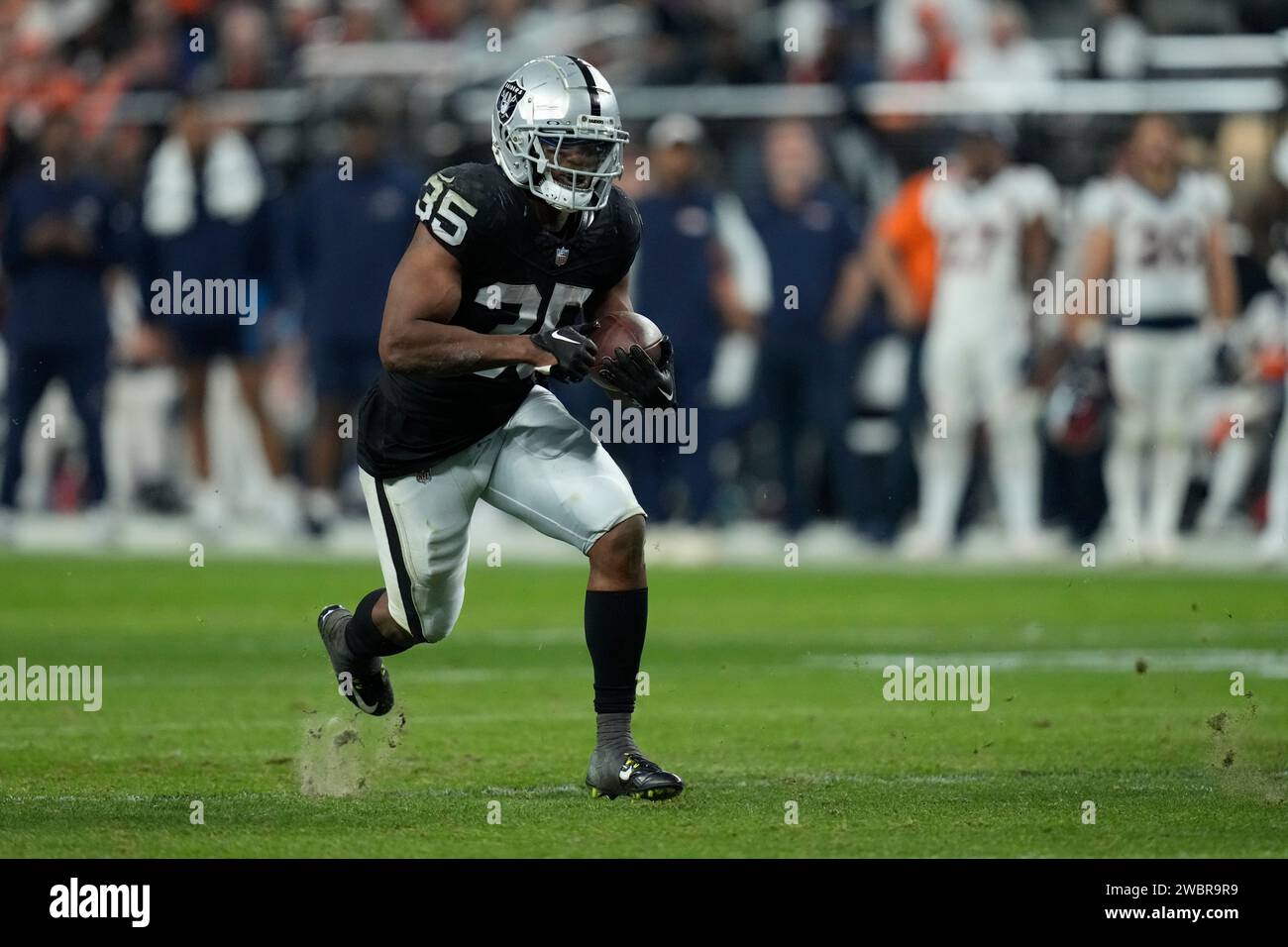 Las Vegas Raiders running back Zamir White (35) runs against the Denver ...