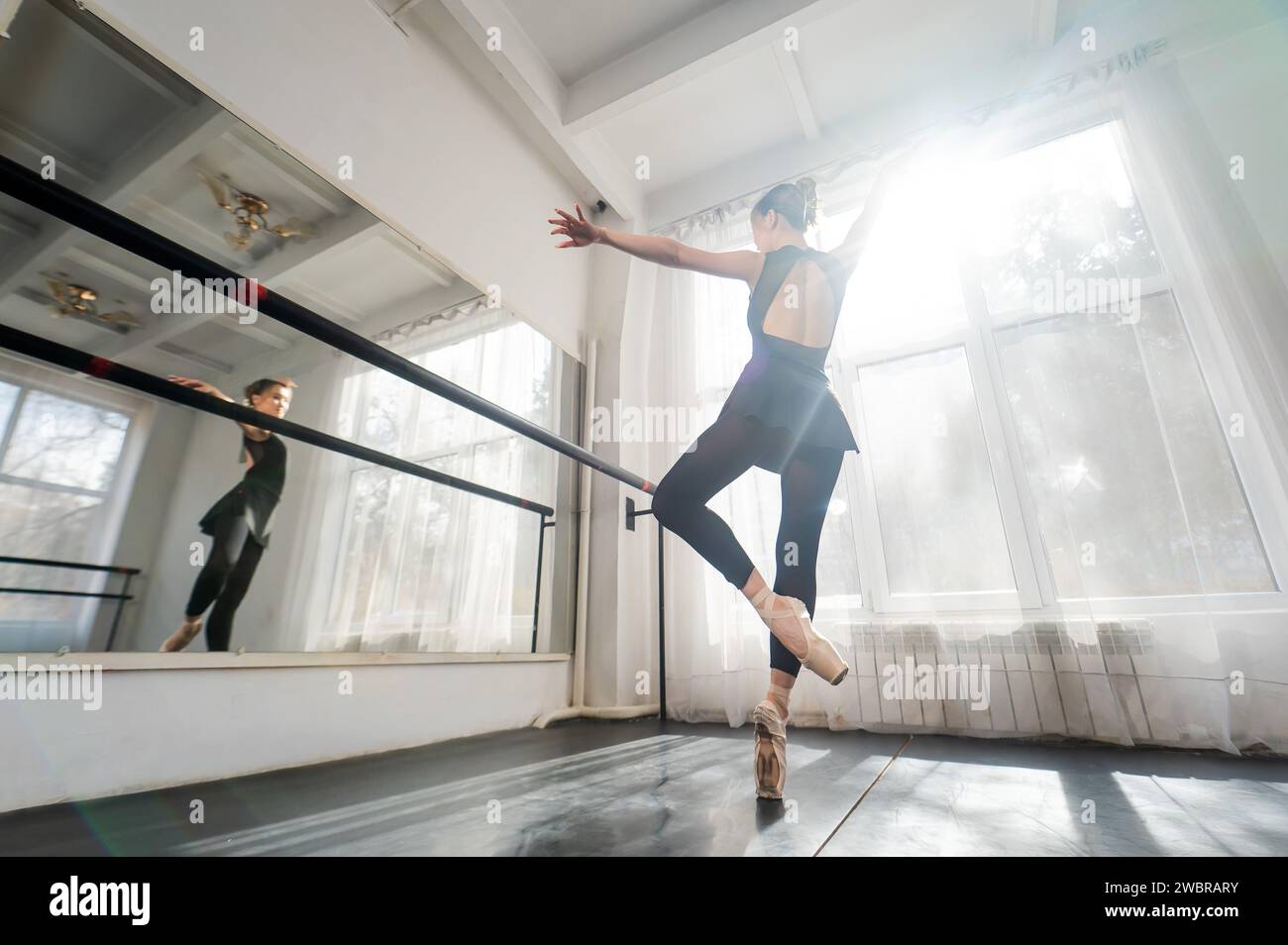 A beautiful Asian woman is dancing at the barre. Ballet dancer Stock ...