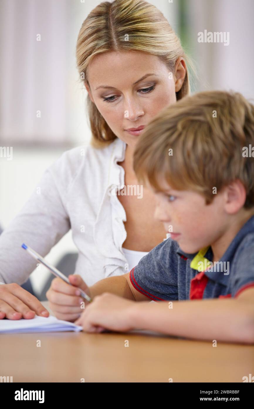 Teacher, student and help with school work in classroom, question and ...