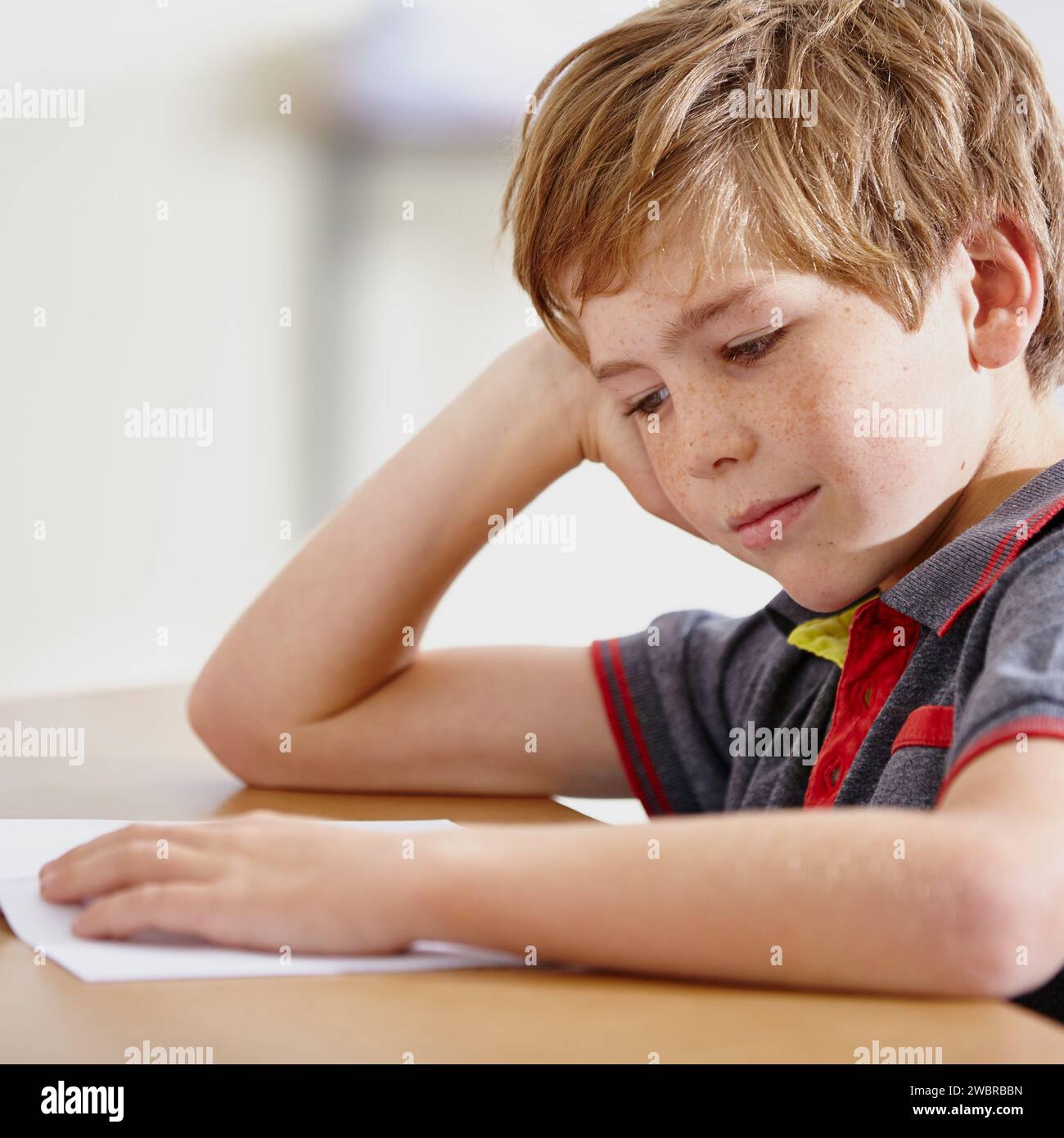 Class, notebook and bored boy at desk, learning and education with ...