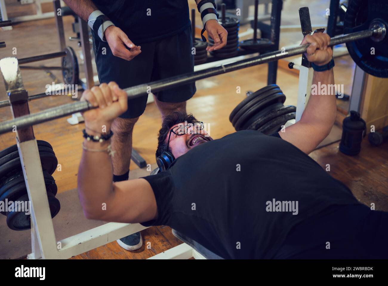 A man exerts excessive force while exercising in a gymnasium Stock ...