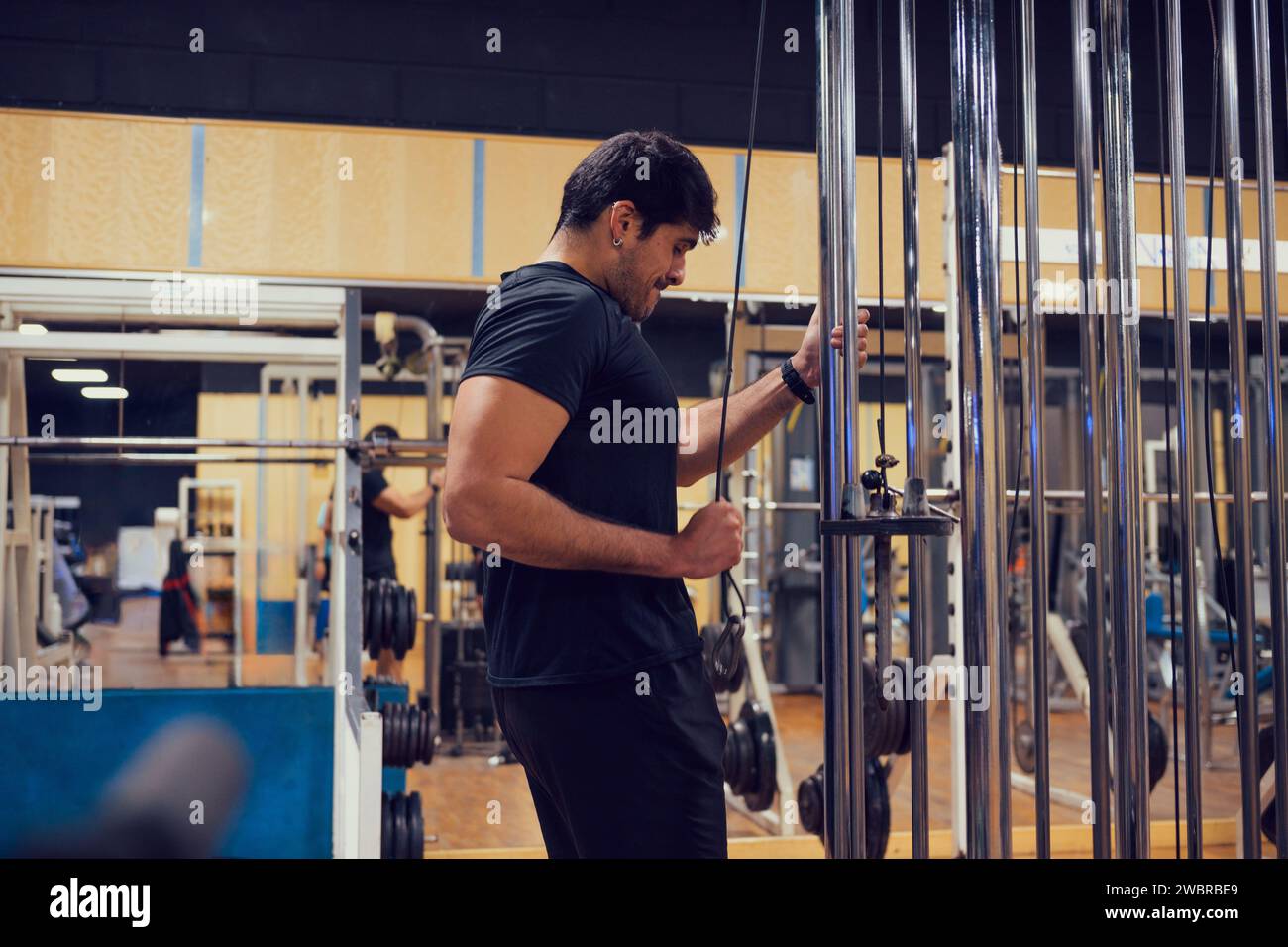 A person is intensely focused on lifting weights at the gym Stock Photo ...