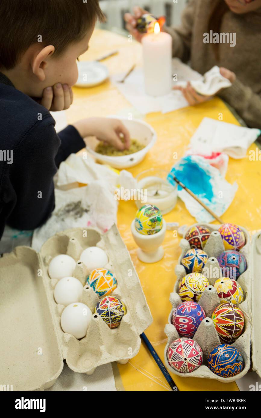 The boy examines the wax for easter eggs Stock Photo - Alamy