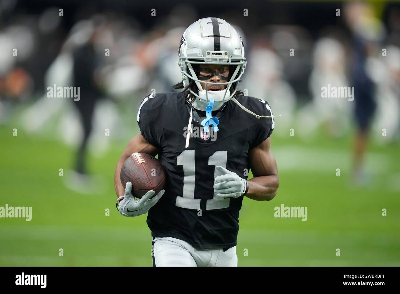 Las Vegas Raiders wide receiver Tre Tucker (11) warms up before an NFL ...