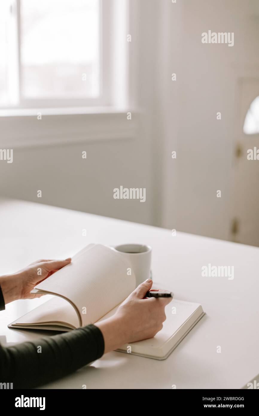 writing in a new notebook with white minimalist aesthetic Stock Photo ...
