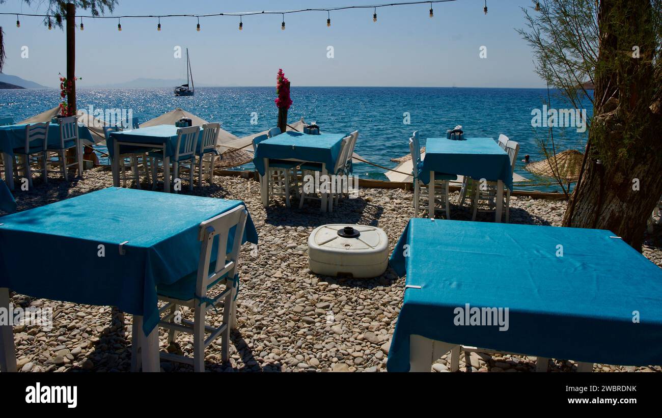 Aegean and Mediterranean coasts at sunset. Wicker umbrellas and sun ...