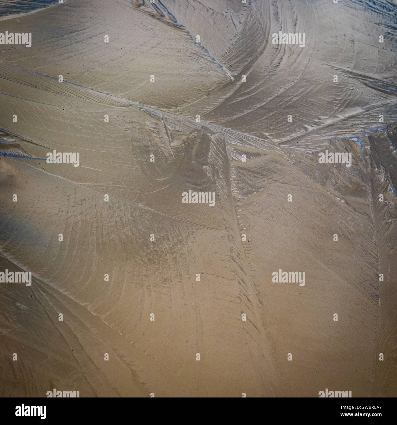 Abstract ice pattern on a muddy puddle Stock Photo - Alamy