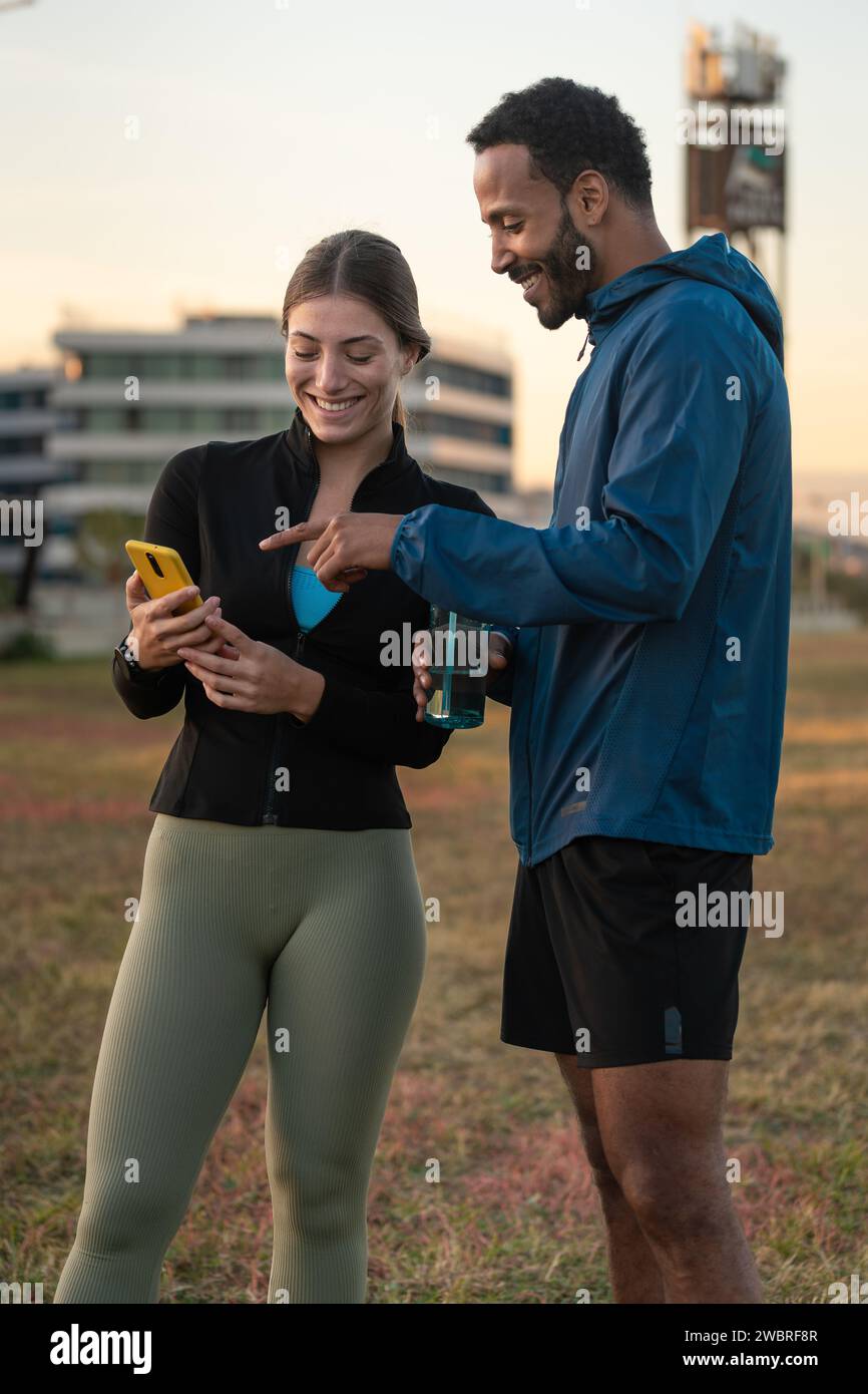 Young athletes using apps on the phone to keep track of their exercise ...