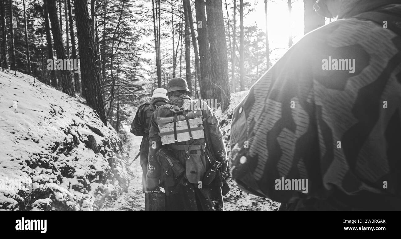 Group Of Soldiers Sub-machine Guns And Bazooka Marching In Forest. Re-enactors Dressed As German ...