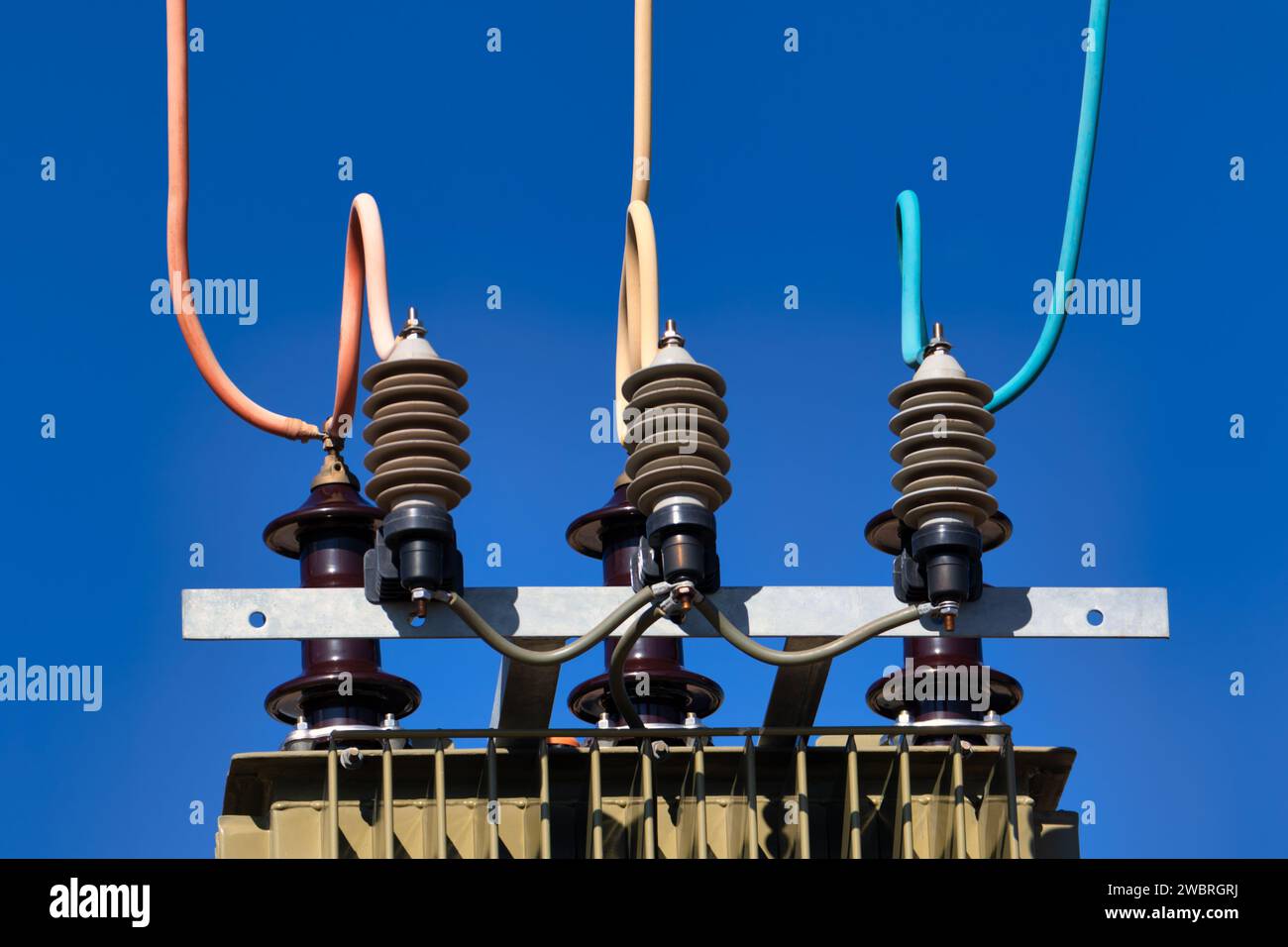 high voltage transformer with ceramic insulators, blue sky background ...