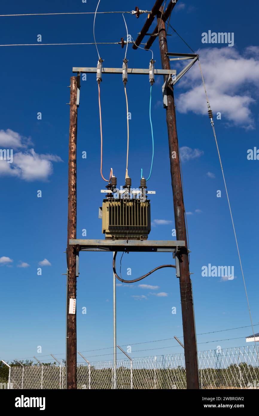 high voltage transformer with ceramic insulators, blue sky background ...