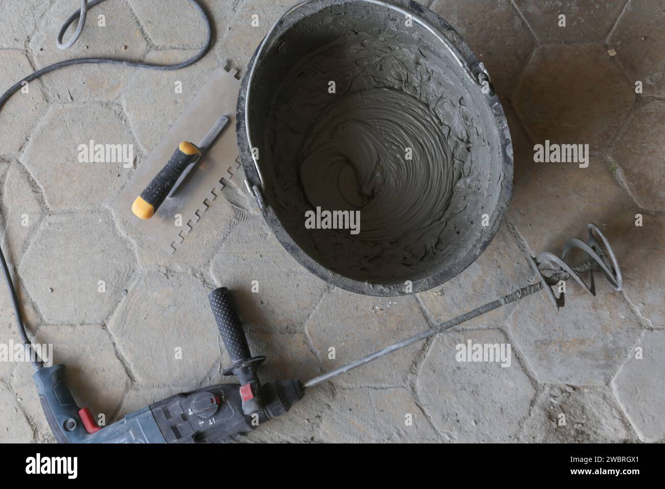 Mortar in bucket and manual mortar mixer on the floor, DIY home ...