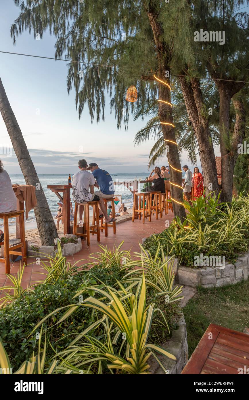People enjoying a drink at the Cassia Cottages seaside bar, Phu Quoc ...
