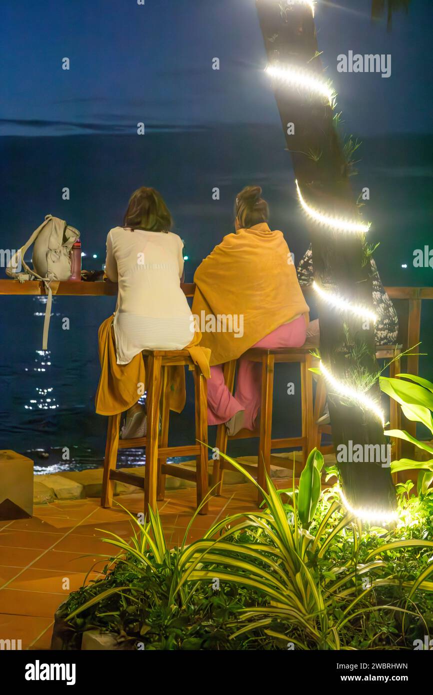 People enjoying a drink at the Cassia Cottages seaside bar, Phu Quoc ...