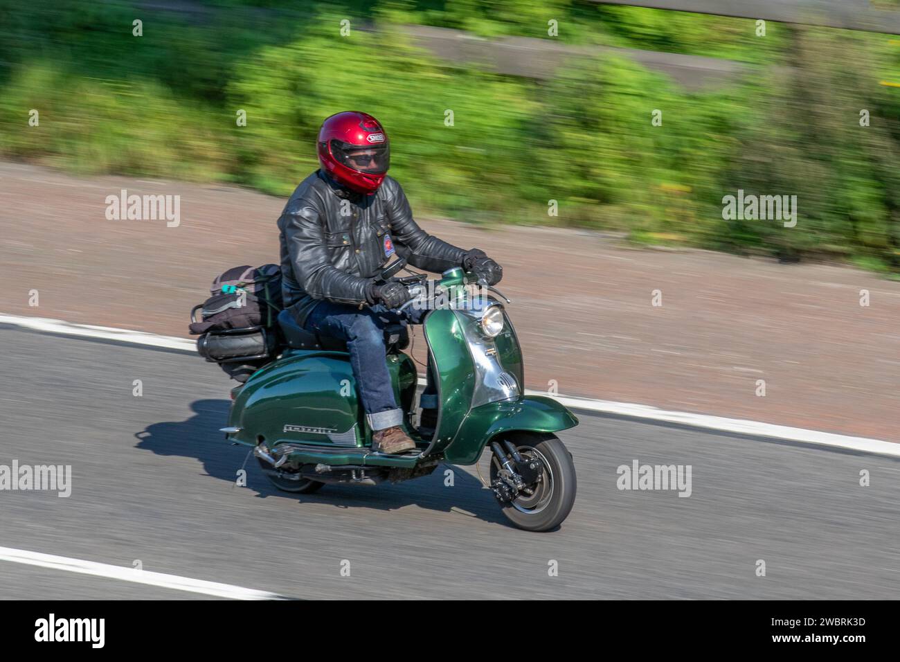 Green Lambretta scooter Innocenti Series 1, Motorbike rider; two ...