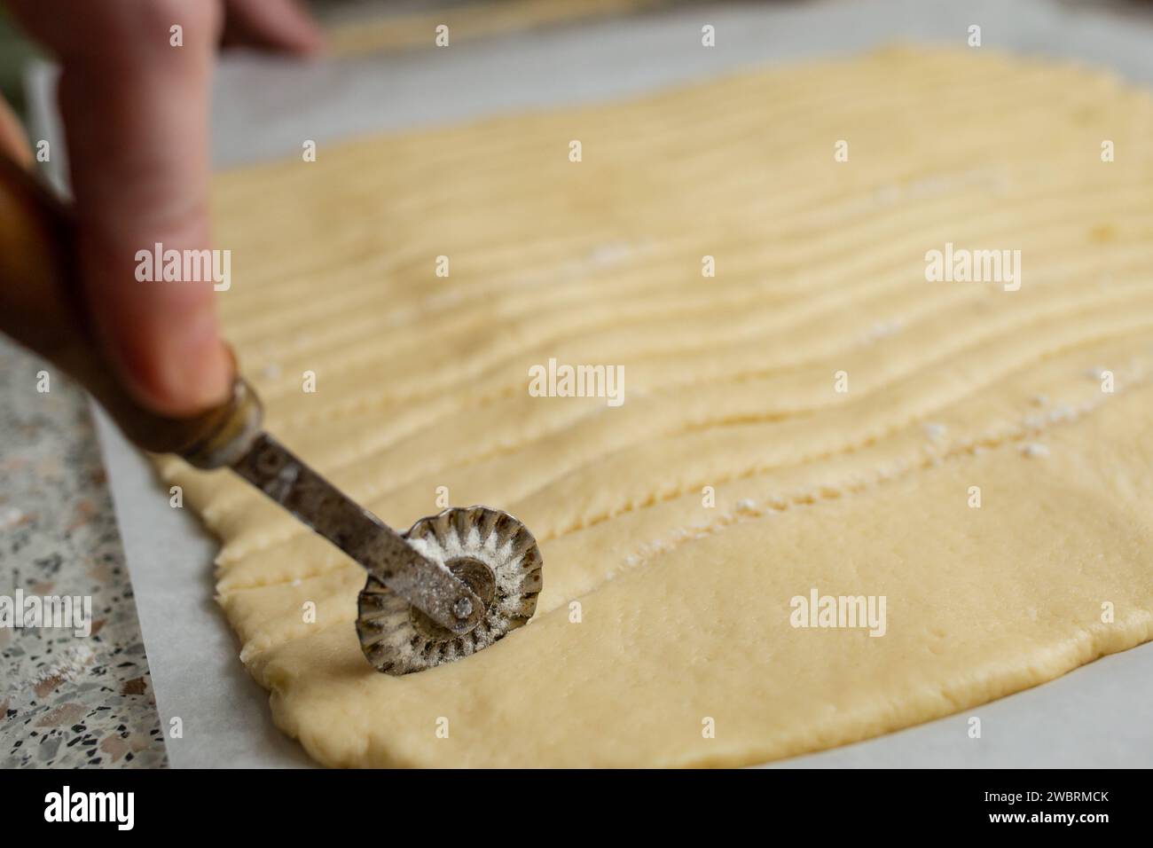 woman hand cutting dough in thin strips, soft focus Stock Photo - Alamy