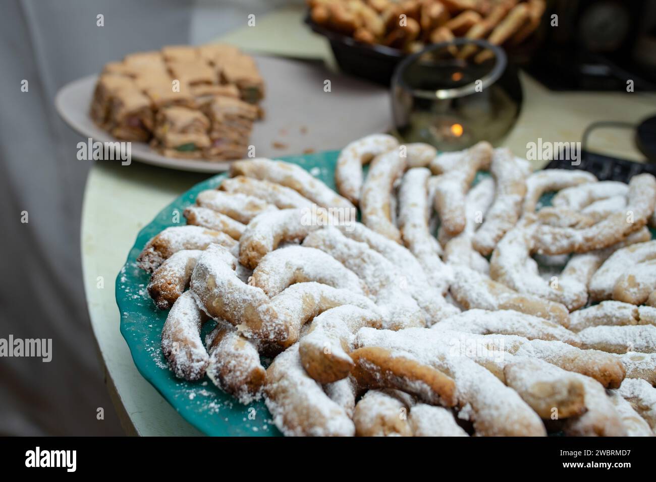Half-moon shaped shortbread cookies sprinkled with powdered sugar, on a ...