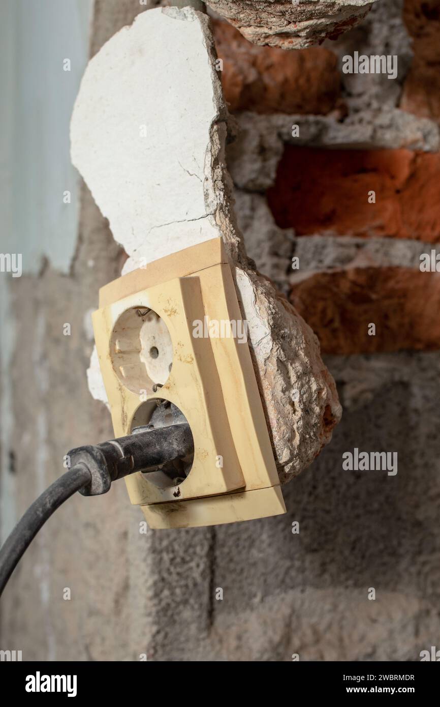 hanging electric outlet due to renovation, construction site detail ...
