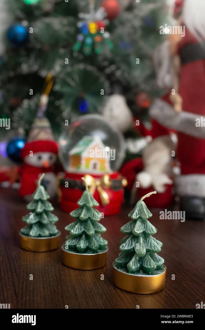 three candles in shape of fir trees, soft focus Stock Photo - Alamy