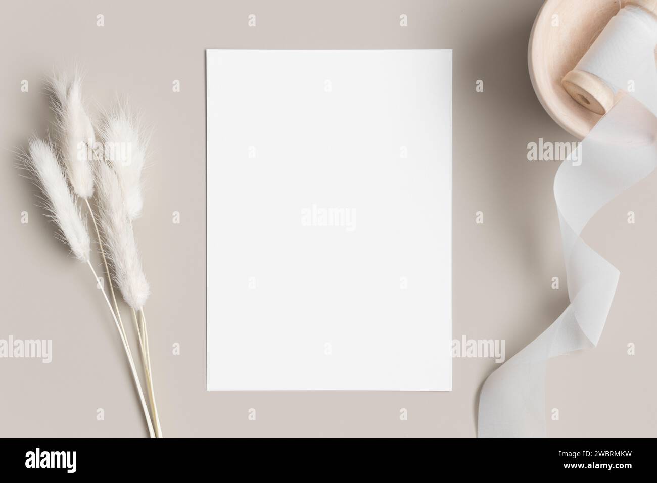 White invitation card mockup with a lagurus on a beige table. 5x7 ratio ...