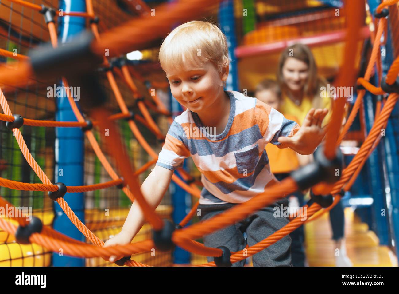 Happy children playing together with a nanny at an amusement park ...