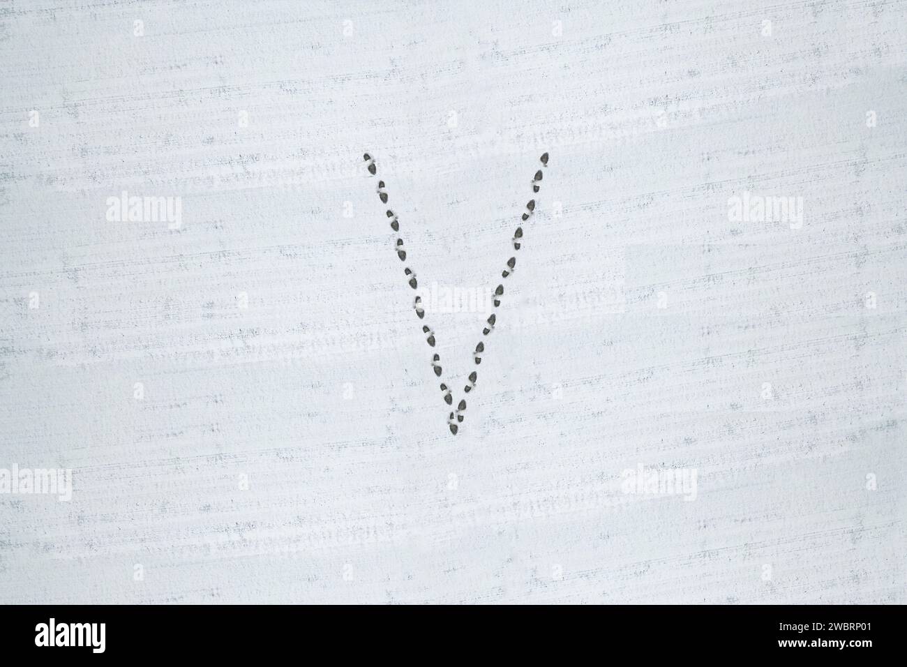 The letter V written in the snow. Winter writings Stock Photo - Alamy