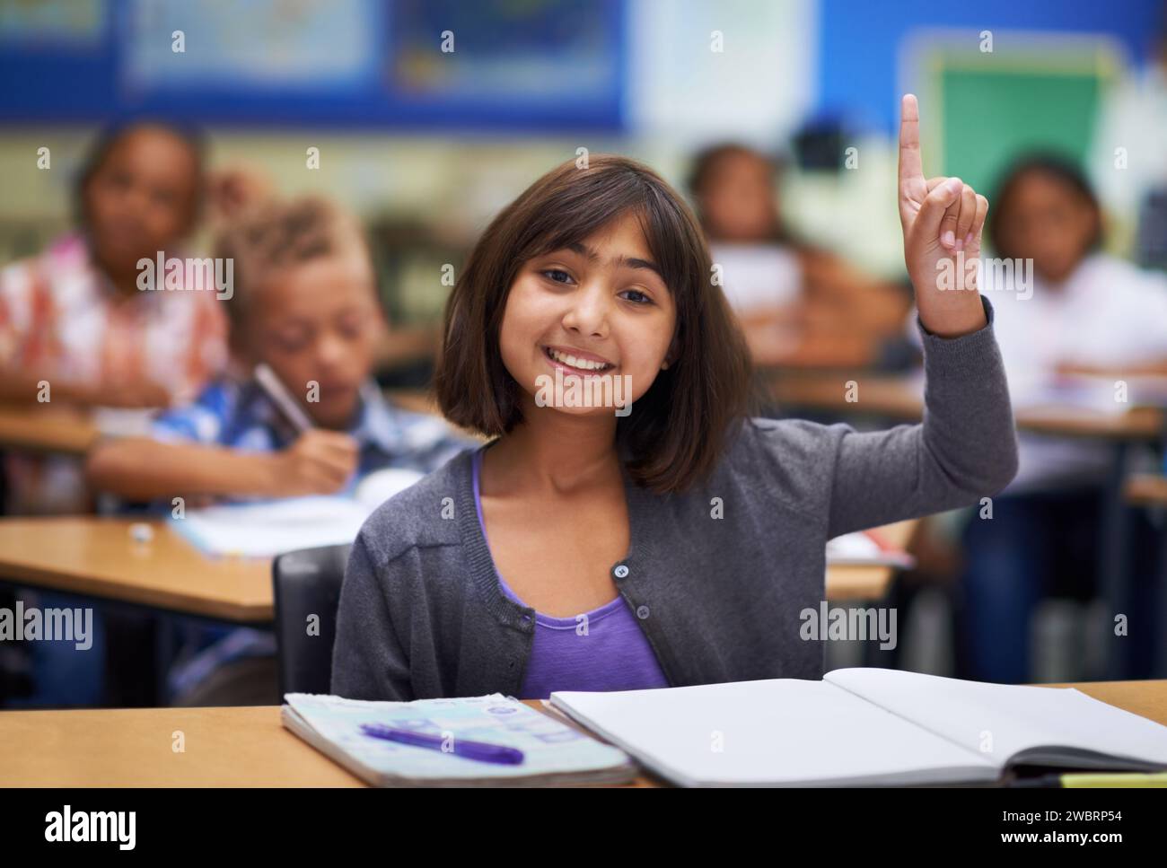 Students, portrait and raise hand in class, elementary school and ask teacher question. Workbook ...