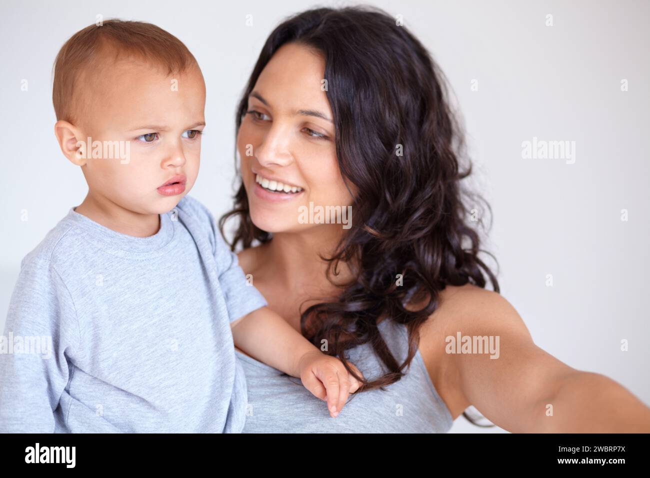 Mom holding toddler in bedroom with smile, bonding and child care with support in morning. Happy ...