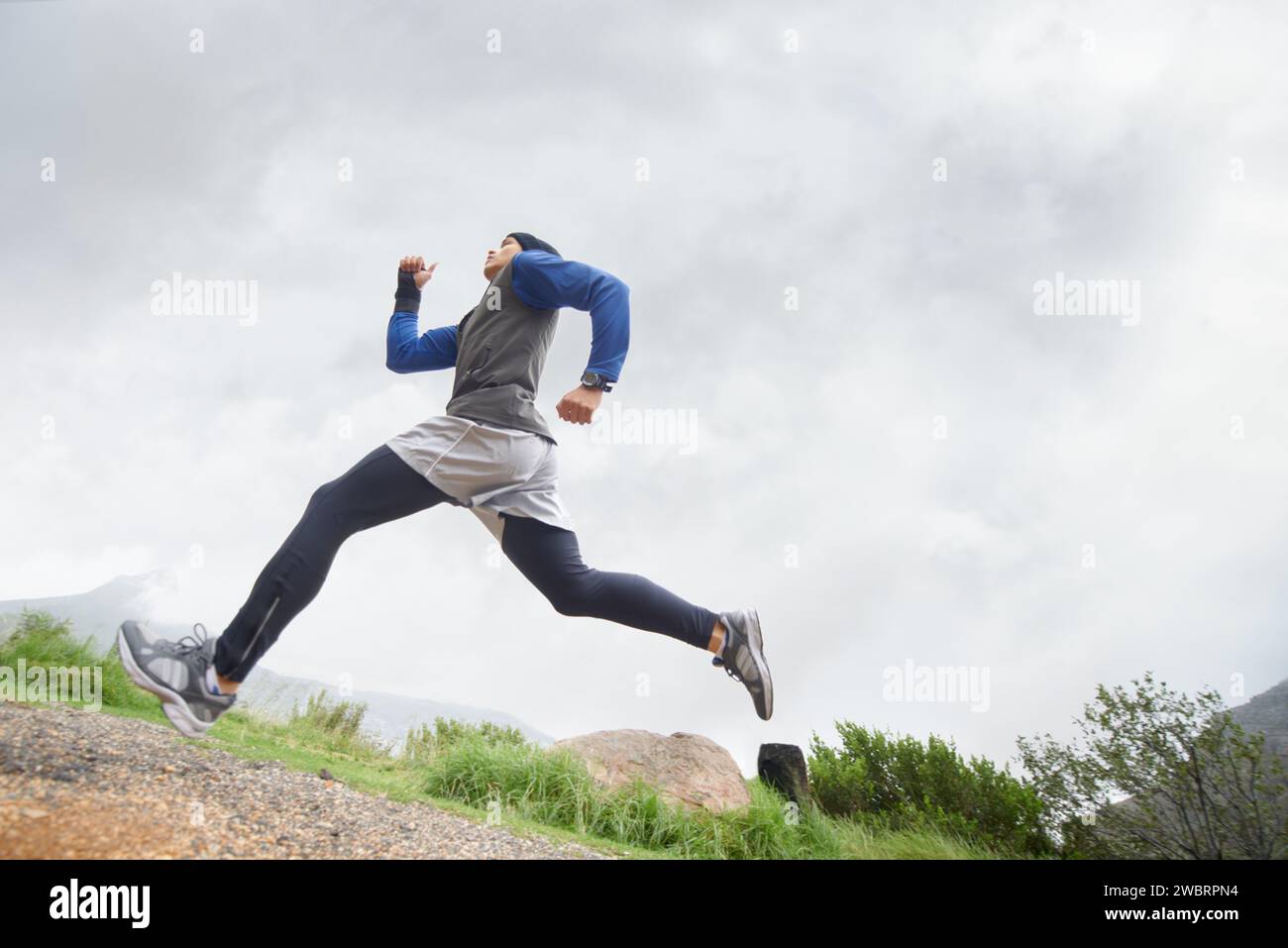 Low angle, runner and man running in nature training, cardio exercise ...