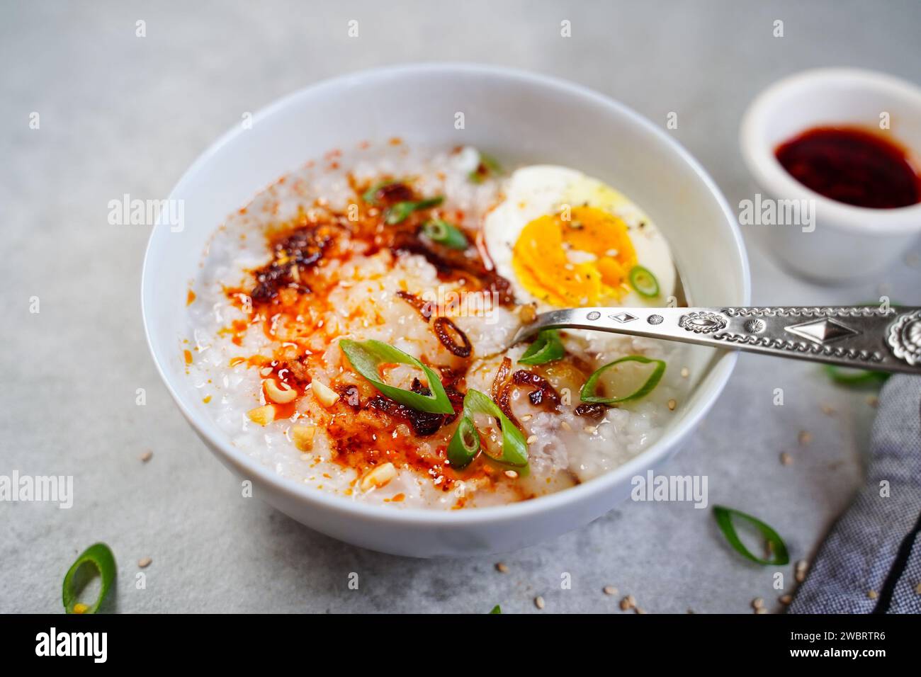 Homemade Asian Chinese style Congee with soft boiled egg fried shallots ...