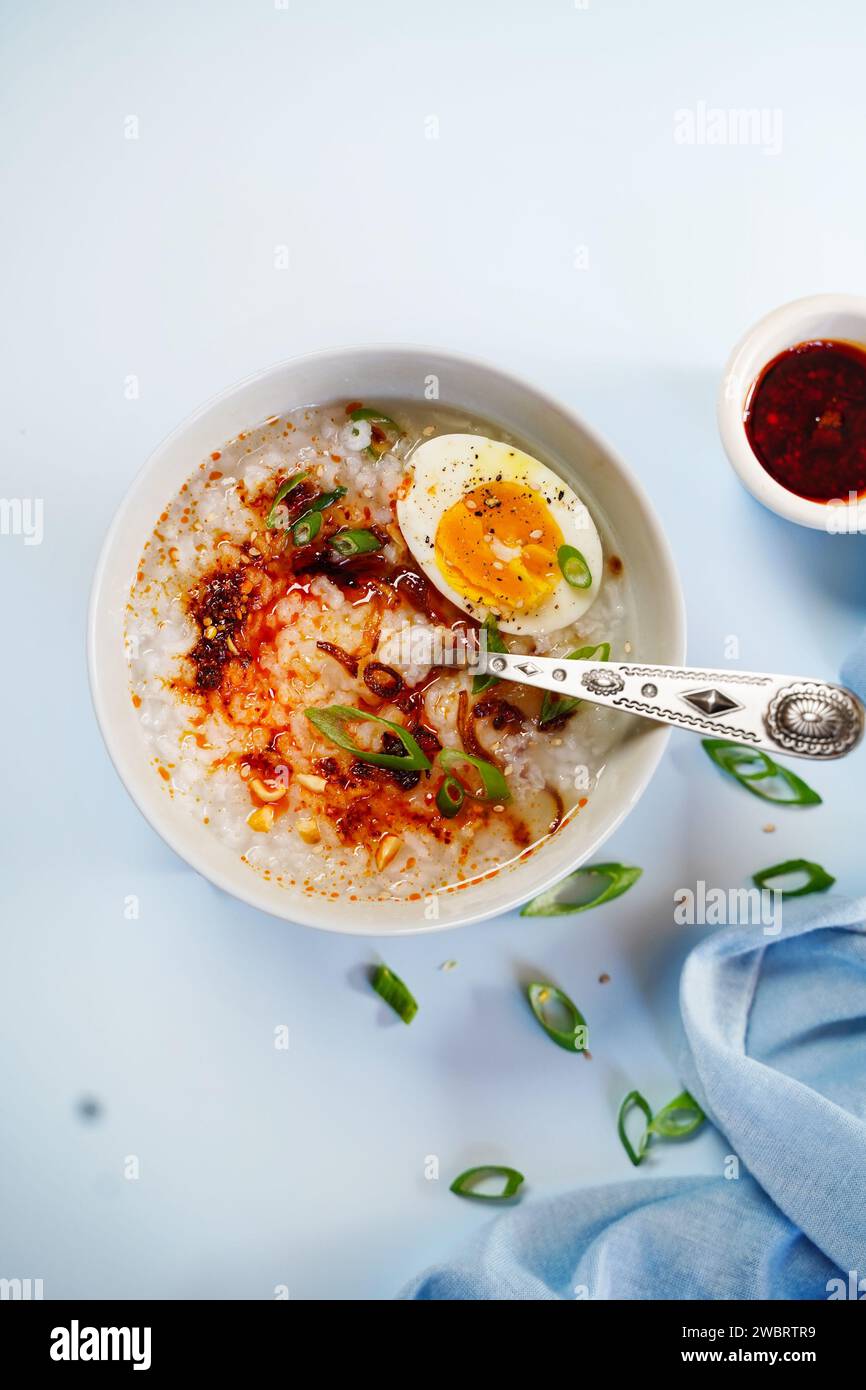 Homemade Asian Chinese style Congee with soft boiled egg fried shallots ...