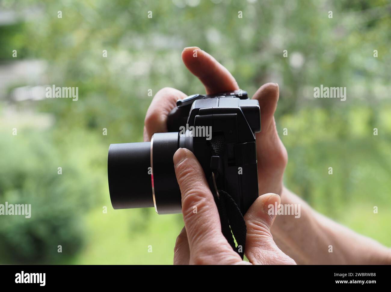 Unrecognisable Person Holding Camera With Both Hands Stock Photo - Alamy
