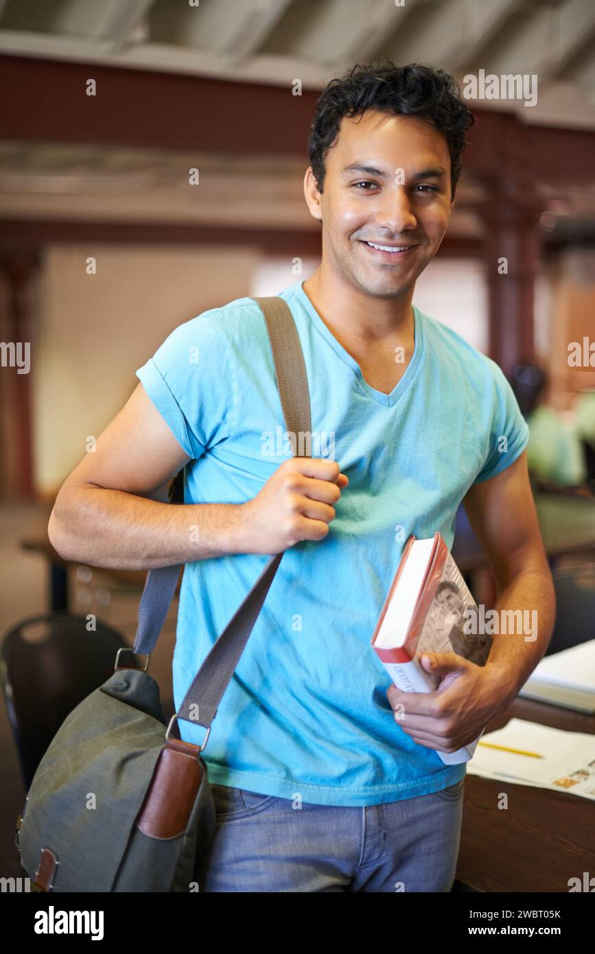 Classroom, man or college student with book, portrait or studying for ...