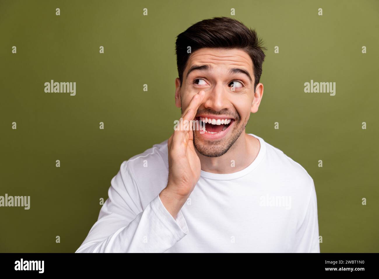 Portrait of young chatterbox man in white jumper touch cheek looking ...