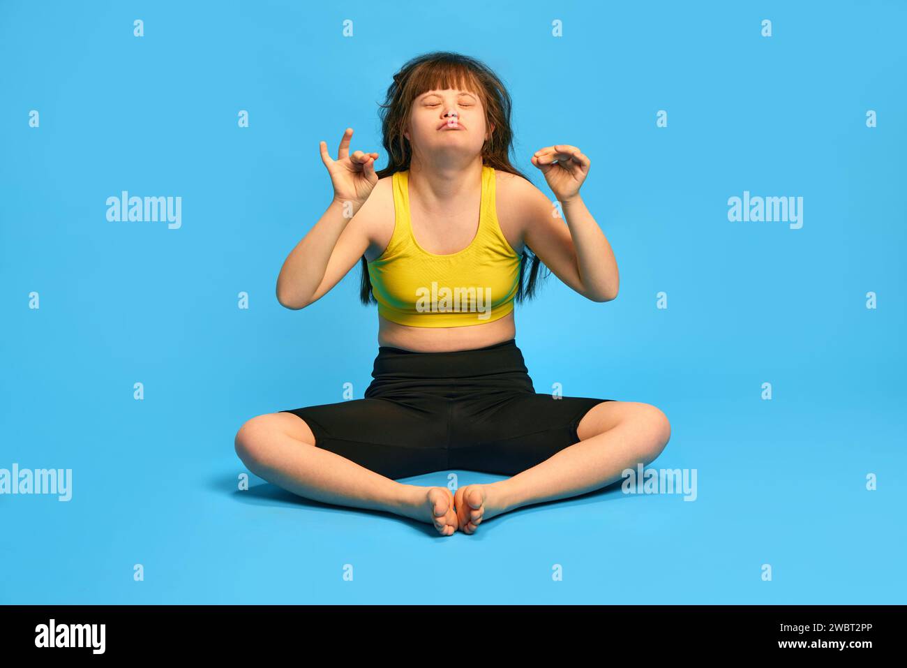 Therapy. Feeling calm and relaxed. Teen girl with down syndrome sitting ...