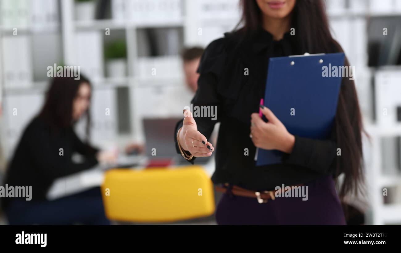 Woman hold document pad give arm as hello Stock Photo - Alamy