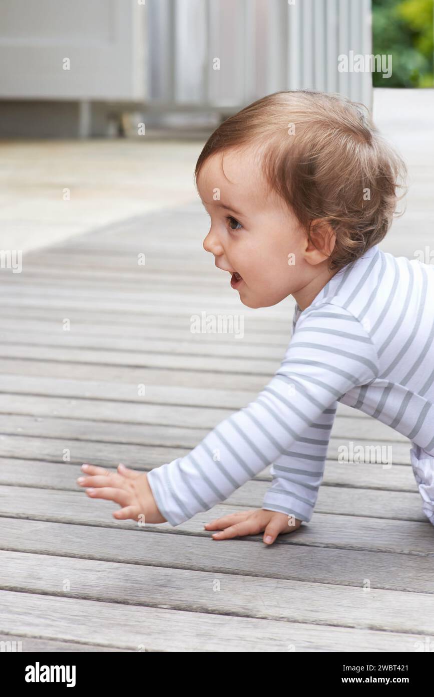 Baby, crawling outdoor and happy on floor, child development and growth ...