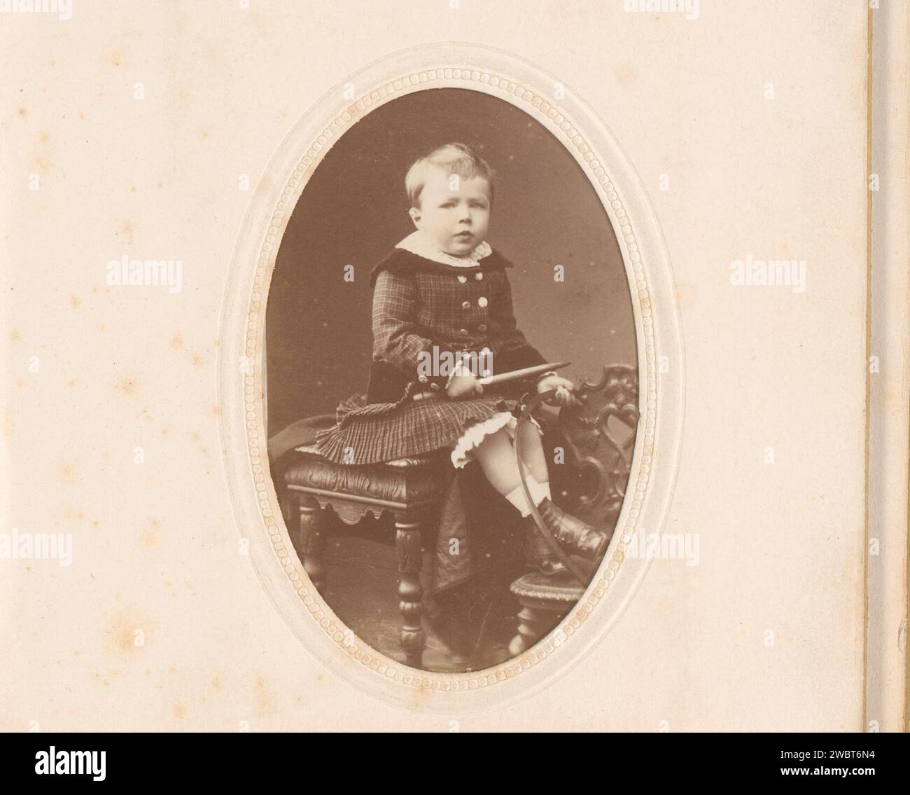 Portrait of a boy with hoop in hand, sitting on a taboeret, referred to ...