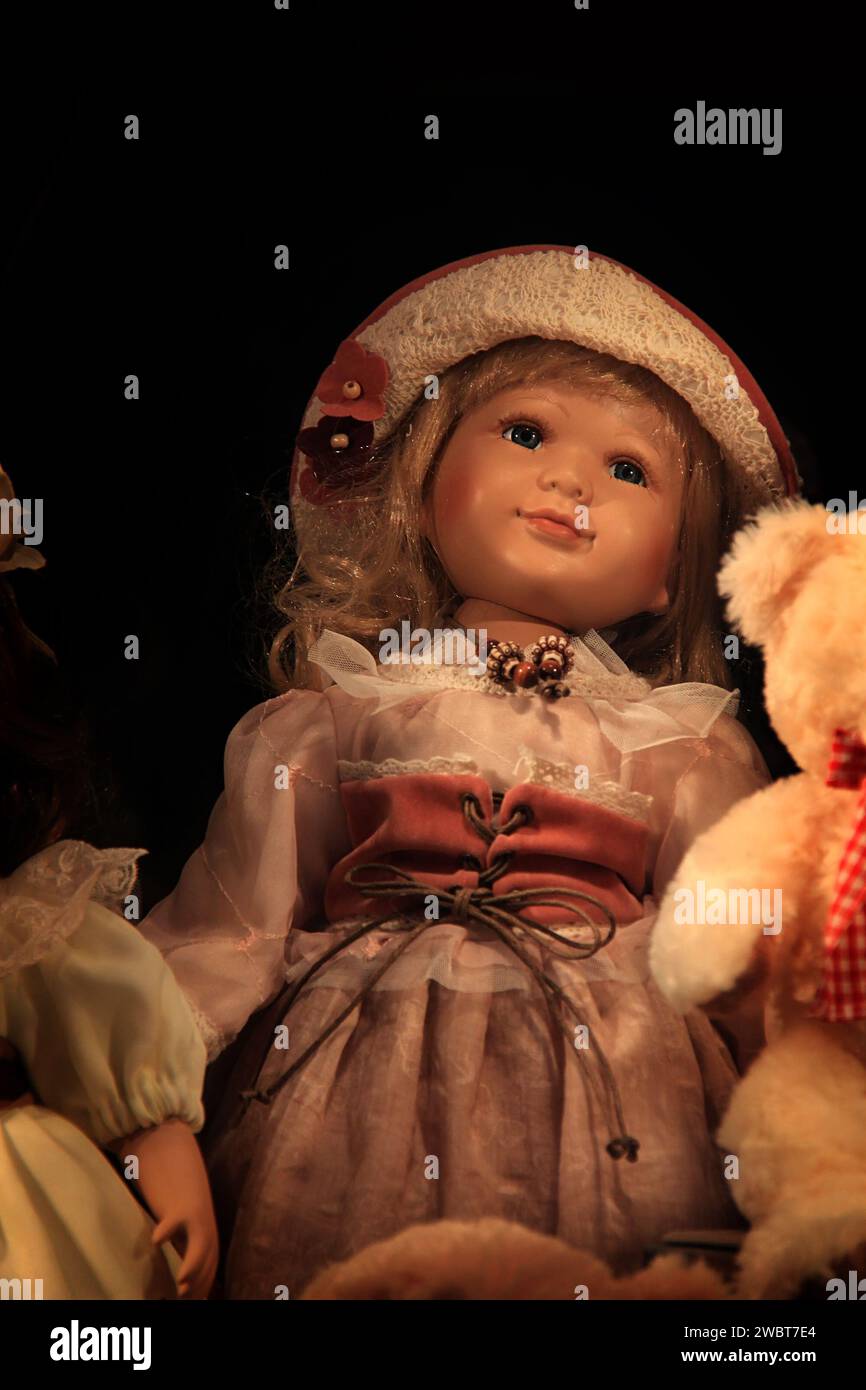 A pretty doll with a nice dress and hat in a display window Stock Photo ...