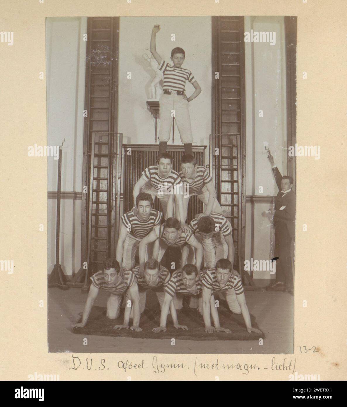 Ten boys form a pyramid during gymnastics, Hendrik Herman van den Berg ...