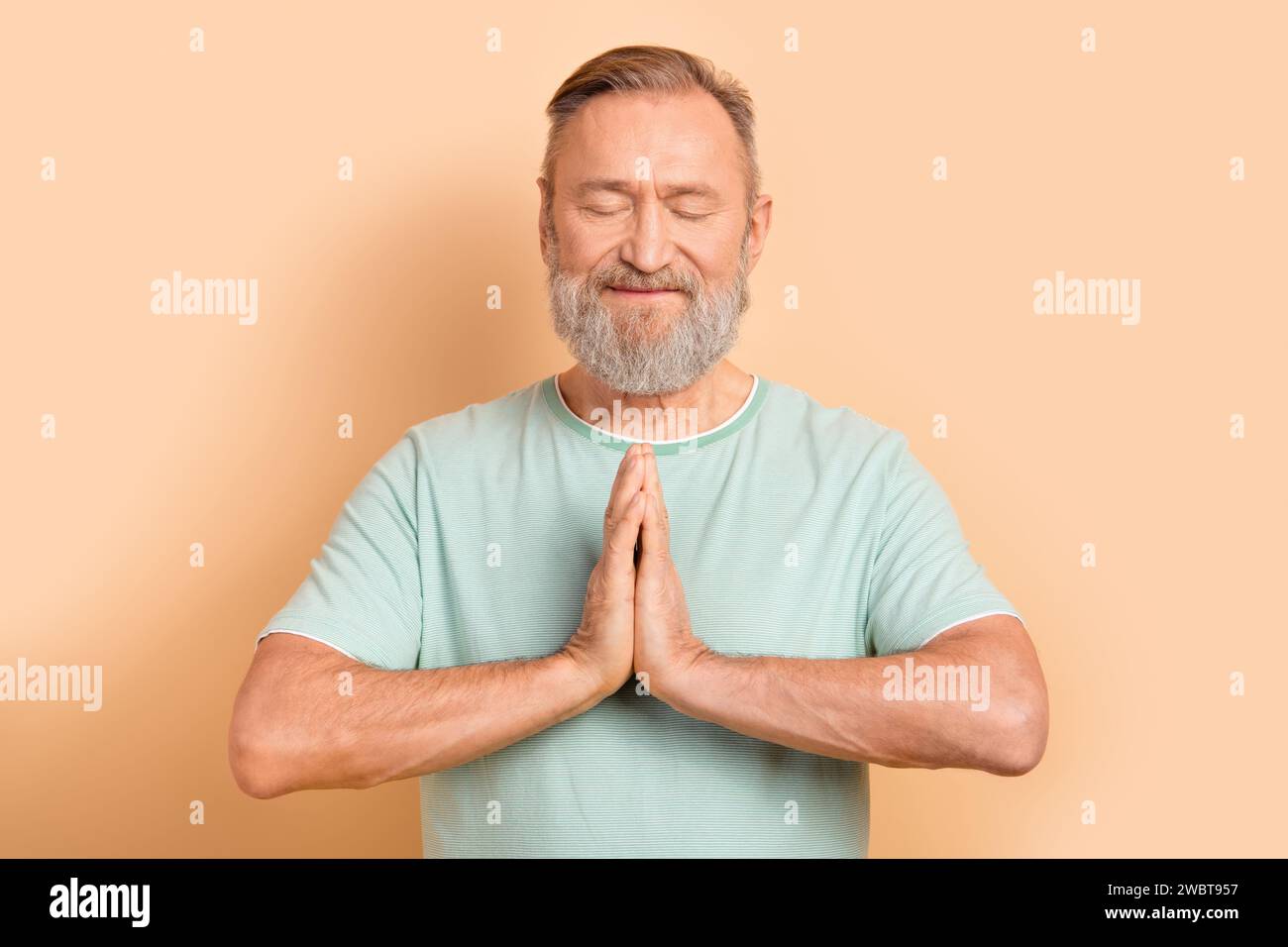 Photo of focused concentrated man showing two hands together dreaming ...