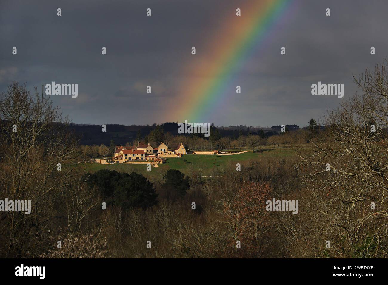A rainbow after rain with a picturesque French village at its end Stock ...
